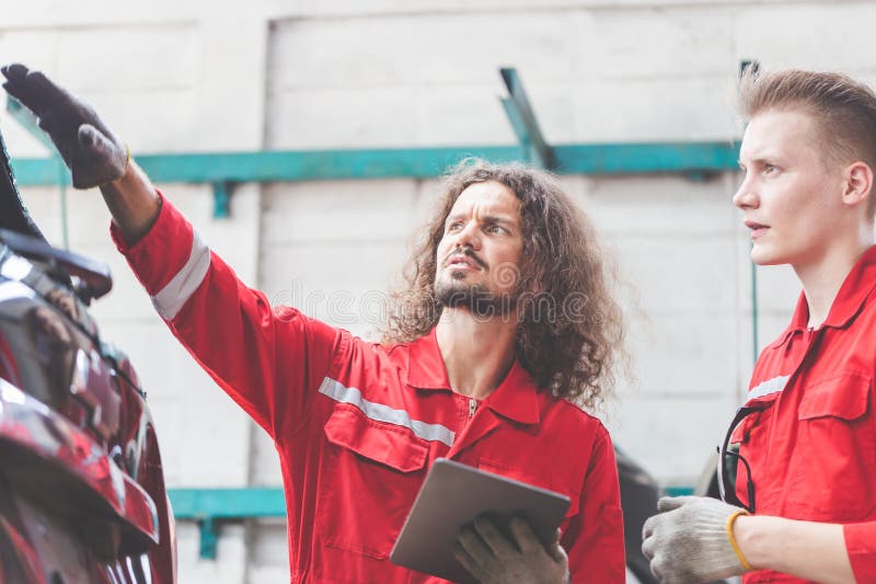 Mechanics Team in Uniform are Working in Auto Service, Technician ...