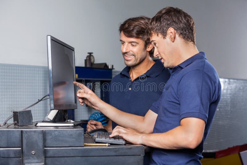 Mechanics Using Computer in Garage Stock Image - Image of pointing ...
