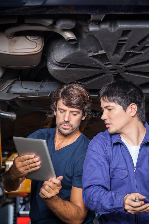 Mechanics Using Digital Tablet Under Lifted Car Stock Photos - Free ...