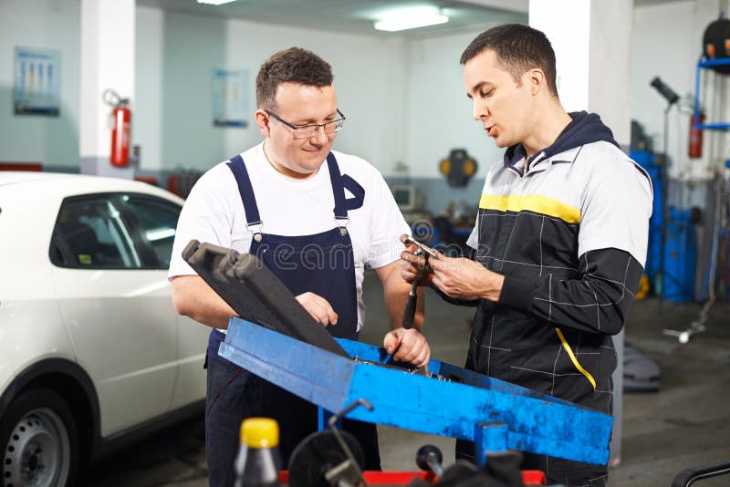Mechanics at work shop stock photo. Image of indoors - 49878910