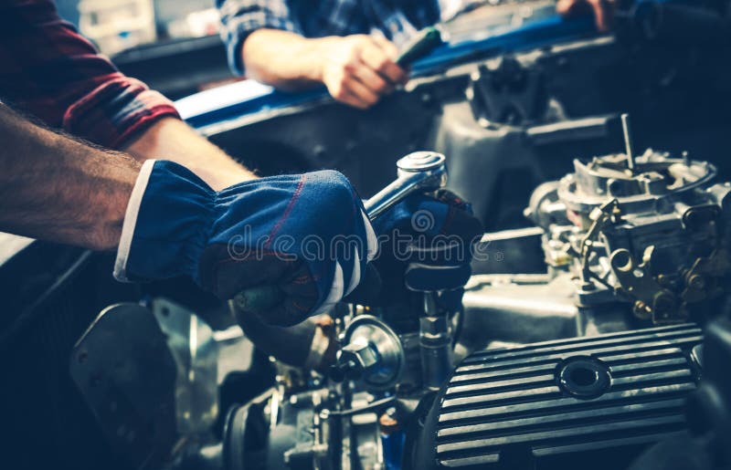 Mechanics Working on Car Engine during Repair in Workshop with Tools ...