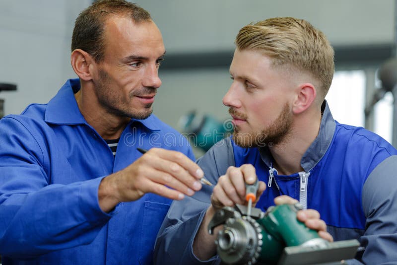 Mechanics Working with Piece Together Stock Image - Image of vehicle ...