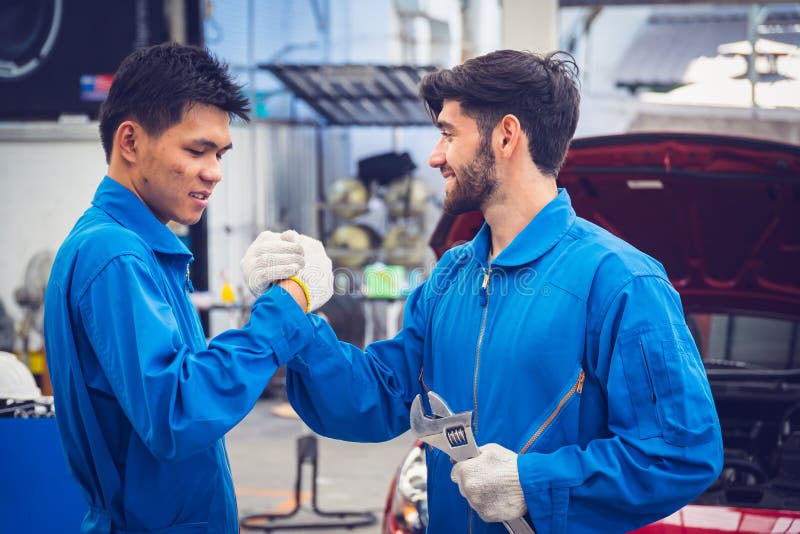 Mechanics Working in the Workshop Garage. Team Work Concepts Stock ...