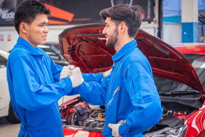 Mechanics Working in the Workshop Garage. Team Work Concepts Stock ...