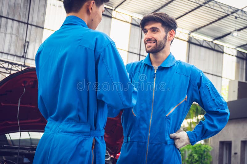Mechanics Working in the Workshop Garage. Team Work Concepts Stock ...