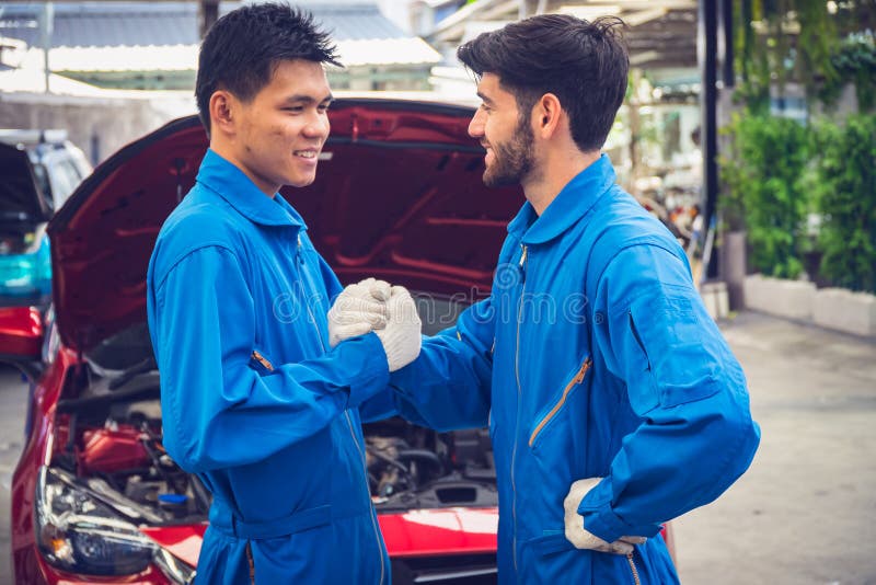 Mechanics Working in the Workshop Garage. Team Work Concepts Stock ...