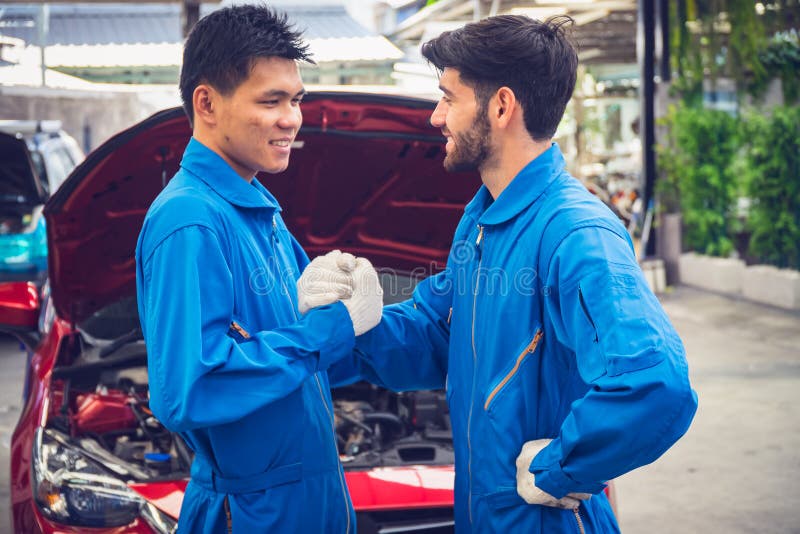 Mechanics Working in the Workshop Garage. Team Work Concepts Stock ...
