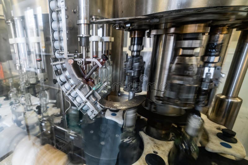 The Mechanism of the Automatic Bottle Capping Machine. Stock Image ...