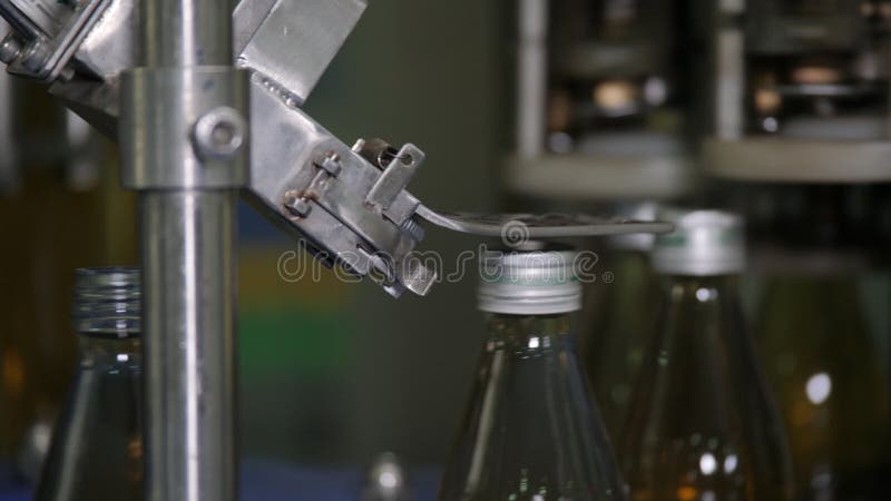 The Mechanism of the Automatic Bottle Capping Machine. Stock Video ...