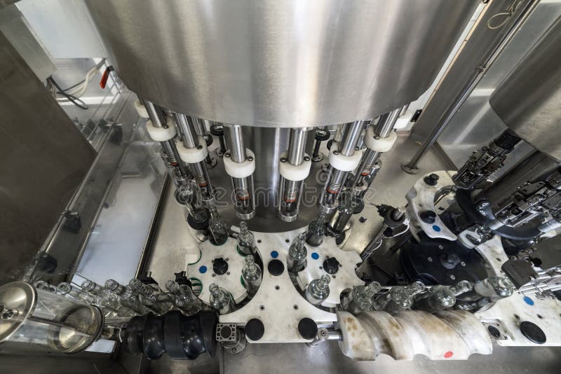 The Mechanism of the Automatic Bottle Capping Machine. Stock Image ...