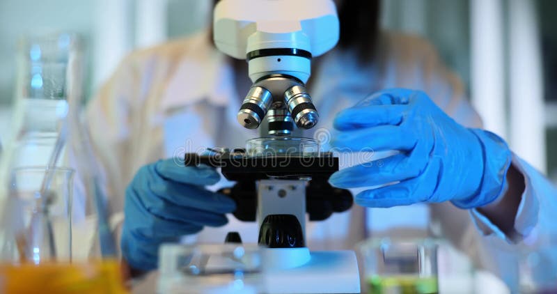Medic Puts Glass Slide with Specimen on Microscope in Lab Stock Footage ...
