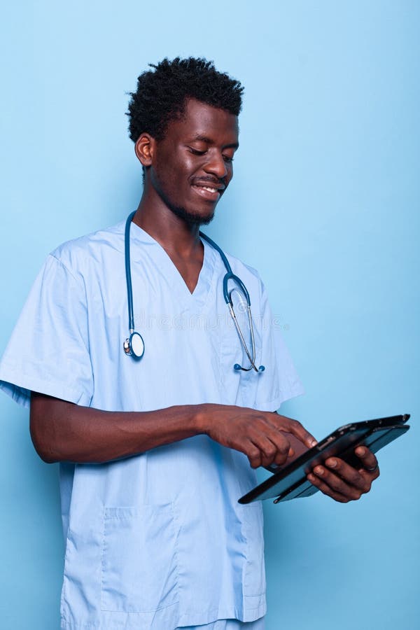 Medical Assistant Looking at Digital Tablet in Hand Stock Photo - Image ...