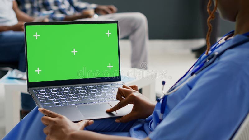 Medical Assistant Looking at Wireless Pc with Greenscreen Stock Photo ...