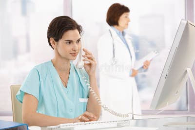 Medical Assistant on Phone, Using Computer Stock Photo - Image of ...