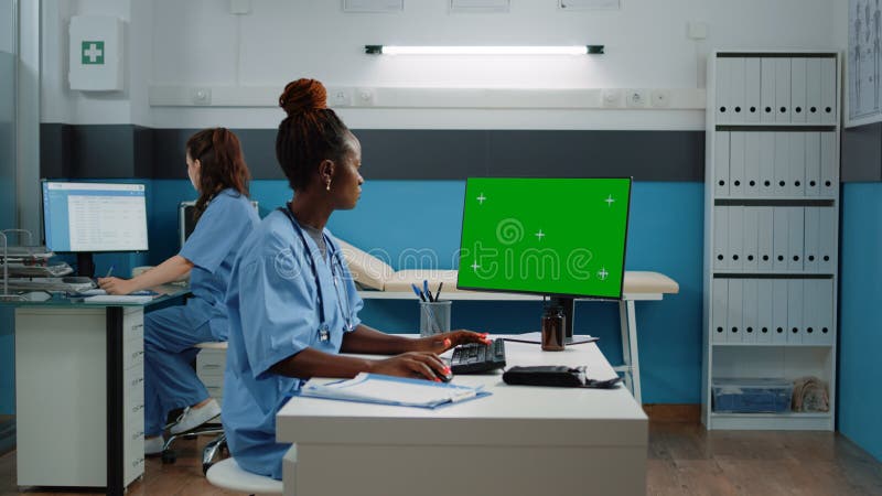 Medical Assistant Using Computer with Horizontal Green Screen Stock ...