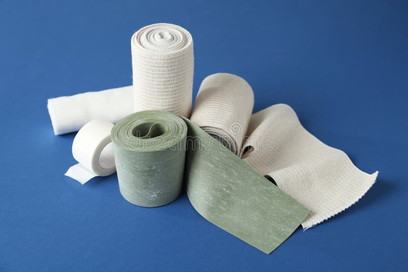 Medical Bandage Rolls and Sticking Plaster on Blue Background Stock ...