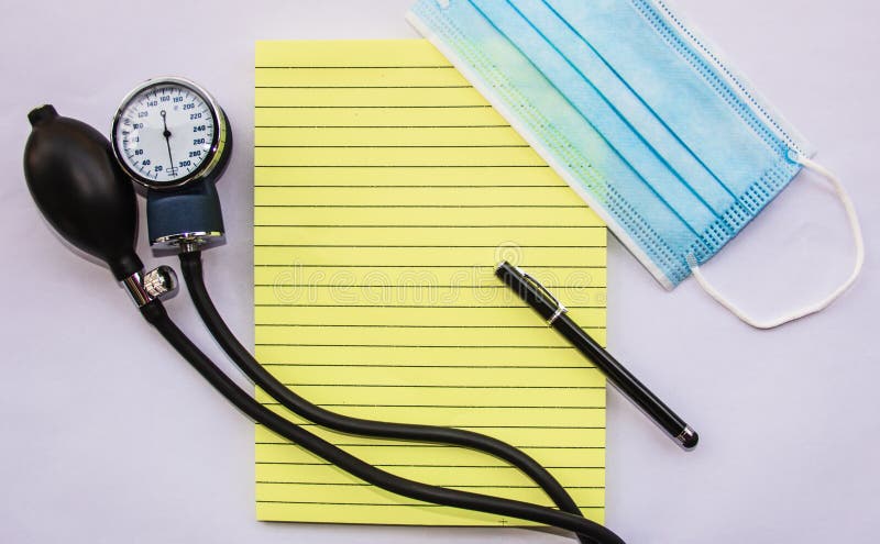 Medical Blue Mask with Notepad Pen and Manual Blood Pressure Reader on ...