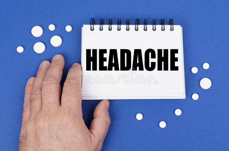 On the Blue Surface of the Tablet, a Hand and a Notepad with the ...