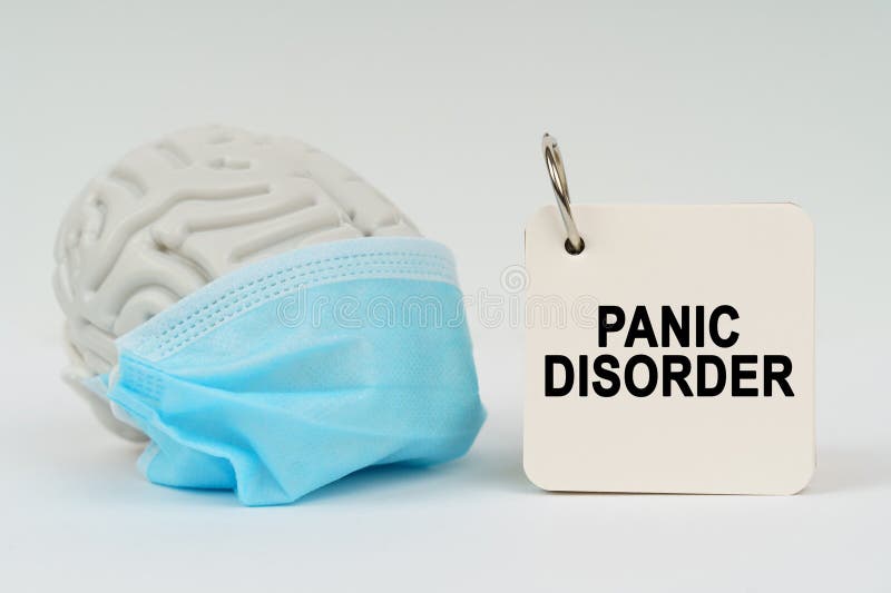 On a White Surface There is a Brain with a Blue Mask and a Notepad with ...