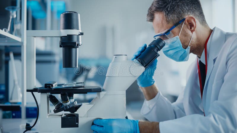 Medical Development Laboratory: Scientist Wearing Face Mask Looking ...