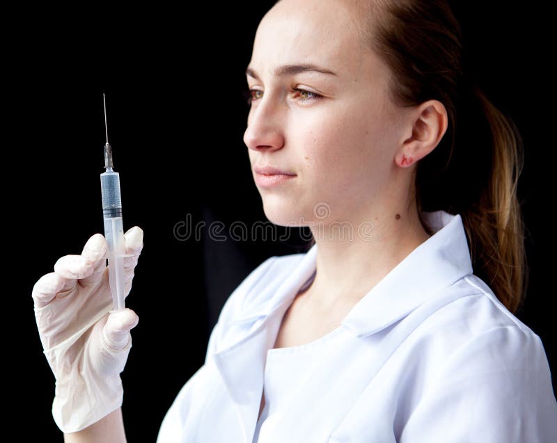 A Medical Doctor Preparing an Injection in a Syringe Stock Photo ...