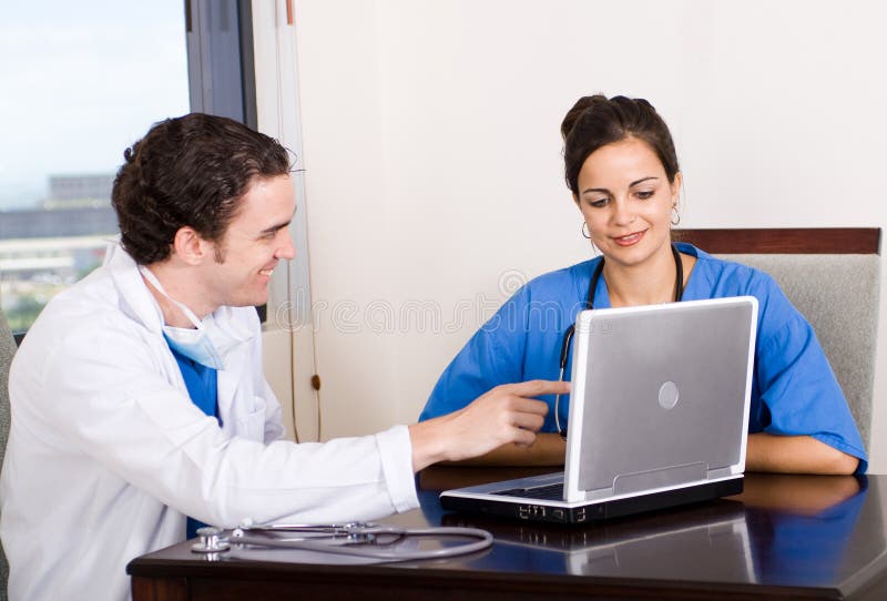 Doctors using computer stock image. Image of colleagues - 8095809