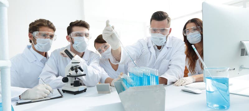 Medical Doctors are Working with Test Tubes and Microscope at the Lab ...
