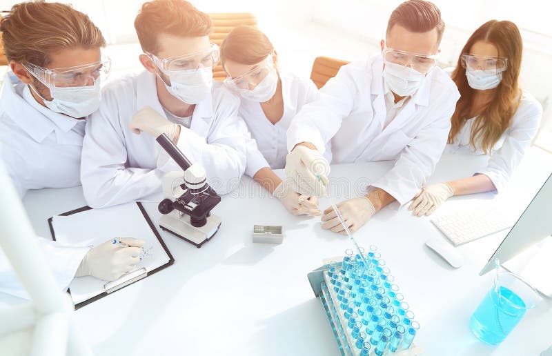 Medical Doctors are Working with Test Tubes and Microscope at Th Stock ...