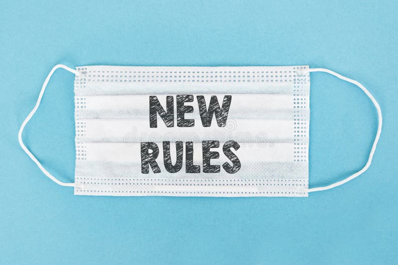 Medical Face Mask with NEW RULES Text on Blue Background Stock Image ...