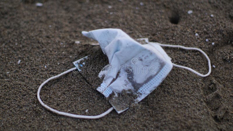 Medical Mask on the Beach Sand Stock Photo - Image of hand, leaf: 222612858