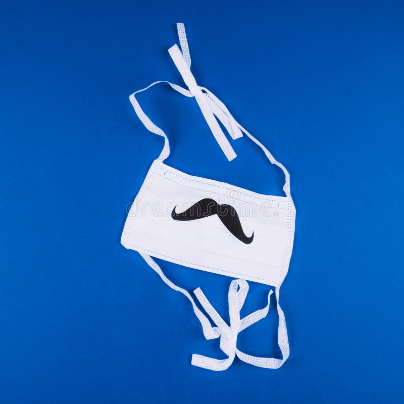 Medical Mask with a Man`s Mustache on a Blue Background. Stock Photo ...