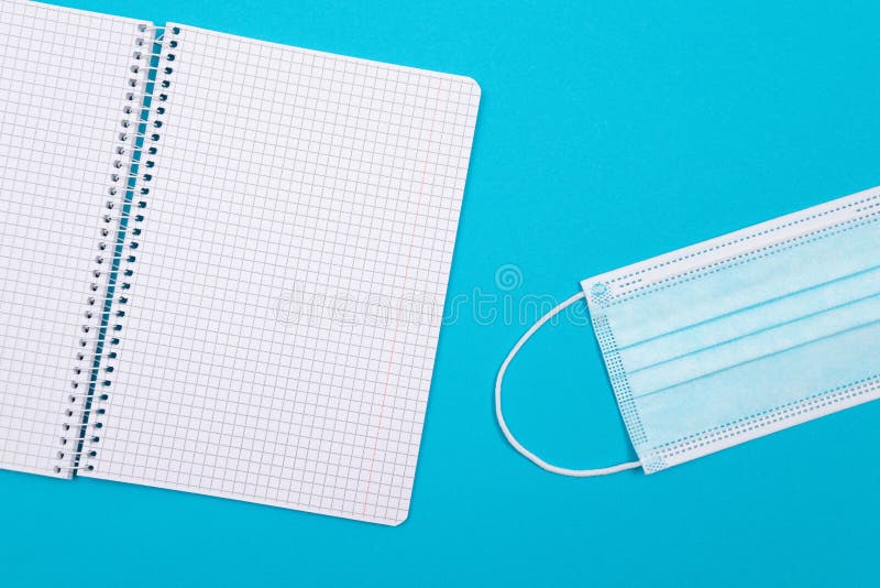 A Medical Mask and a Note Pad Lying on Blue Table Stock Image - Image ...