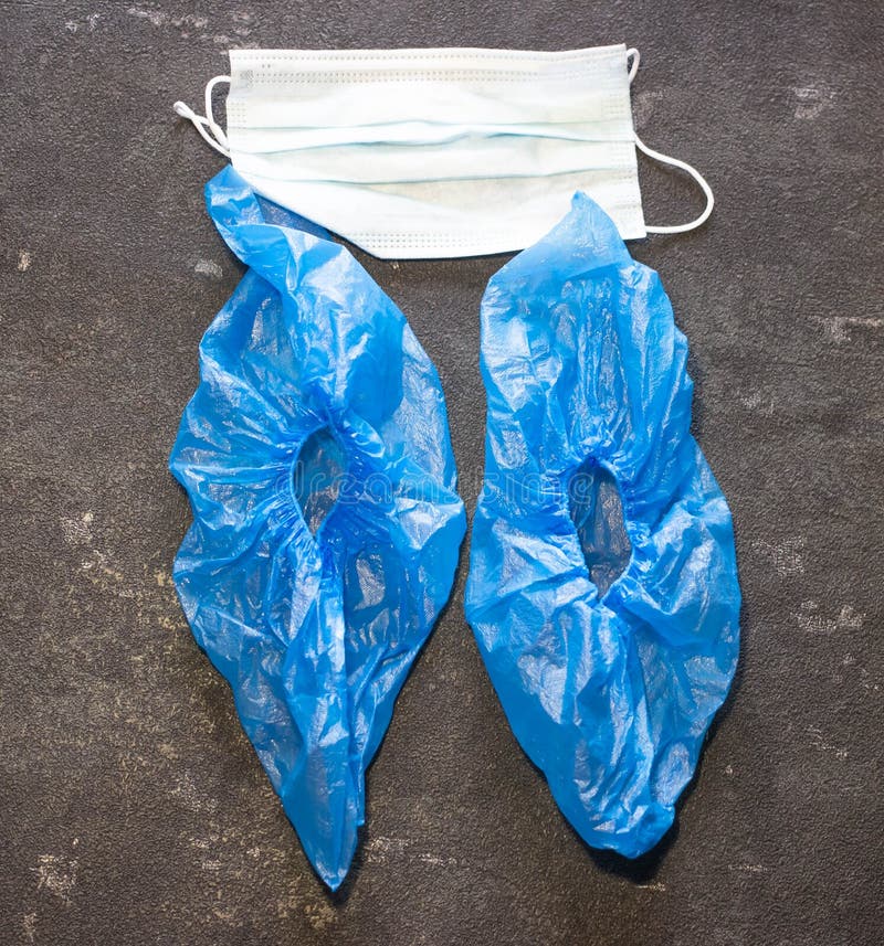 Medical Mask and Shoe Covers on a Black Background. Virus and Flu ...