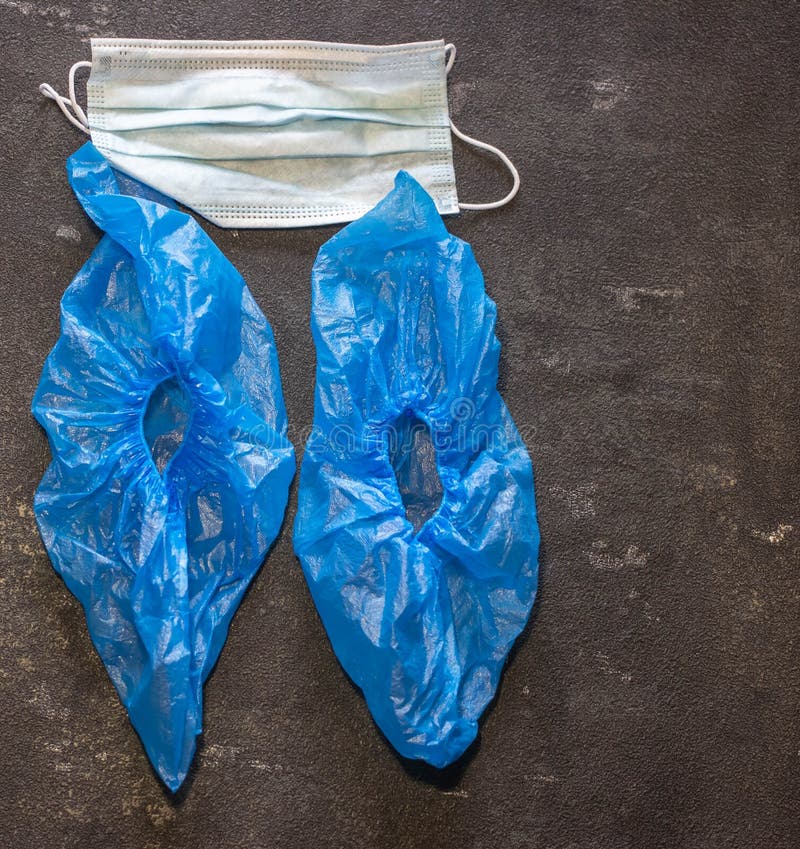 Medical Mask and Shoe Covers on a Black Background. Virus and Flu ...