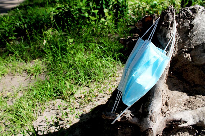 A Medical Mask Stretched Over the Root of a Tree Stock Photo - Image of ...