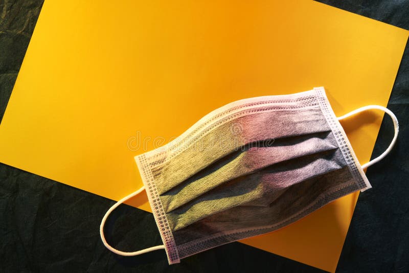 Medical Mask or Surgical Earloop Mask on Yellow and Black Paper ...