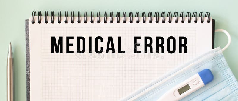 A Medical Mask and a Thermometer are on the Notepad. MEDICAL ERROR Text ...
