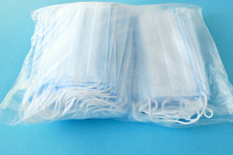 Medical Packing Face Masks on Blue Background, Closeup Stock Image ...