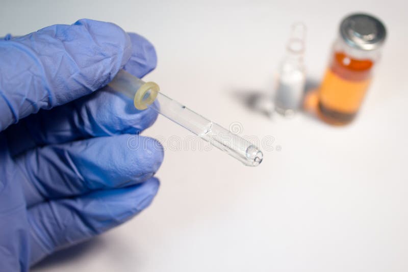 Medical Pipette with a Drop of Medication Over the Patient`s Ear Stock ...