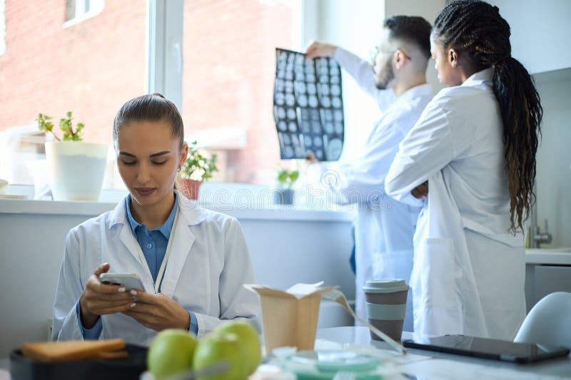 Medical Professionals Analyzing X-Ray in Bright Office Stock Photo ...