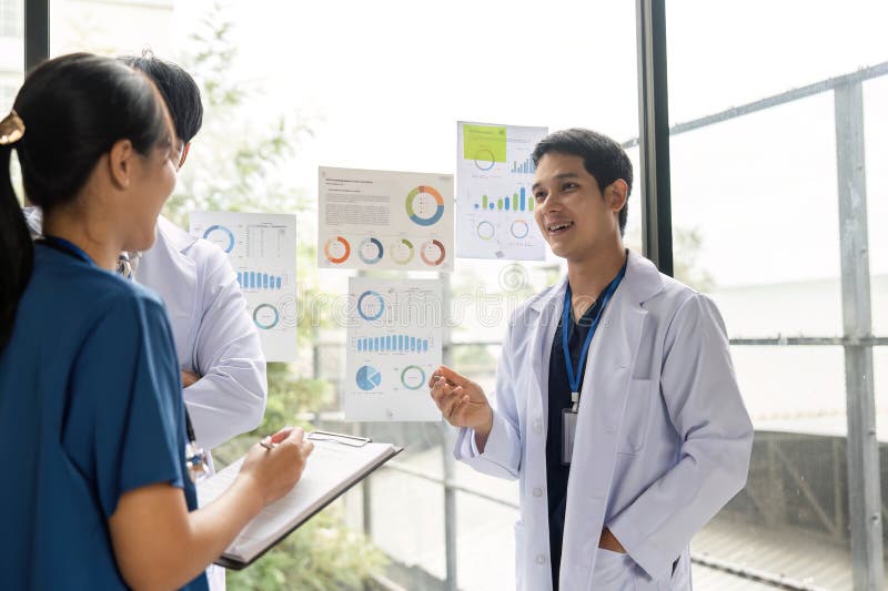 Doctors Collaborating on Healthcare Strategies with Data Visuals Stock ...