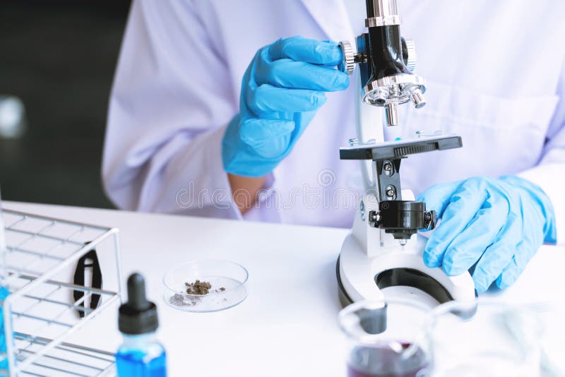 Medical Research Asian Scientist Working with Microscope Doing Research ...