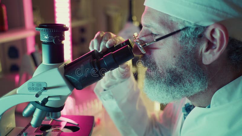 Scientist Analyzing Sample with Microscope in Laboratory Stock Footage ...