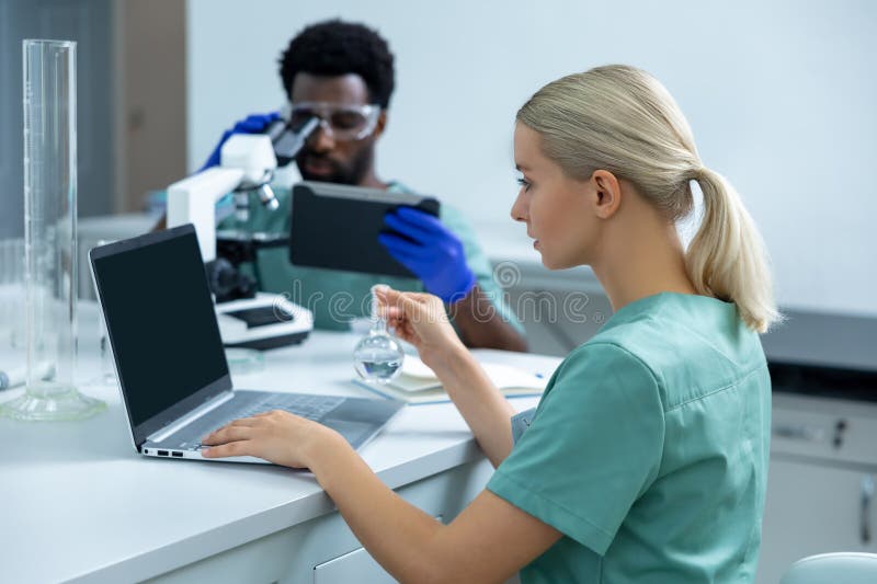 Medical Researchers in Laboratory Discussing in Pharmacology Using ...