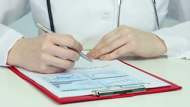 Scientist Examining Graph Curves, Conducting Medical Research ...
