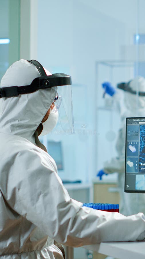 Medical Scientist in Ppe Suit Working with DNA Scan Image Typing on Pc ...