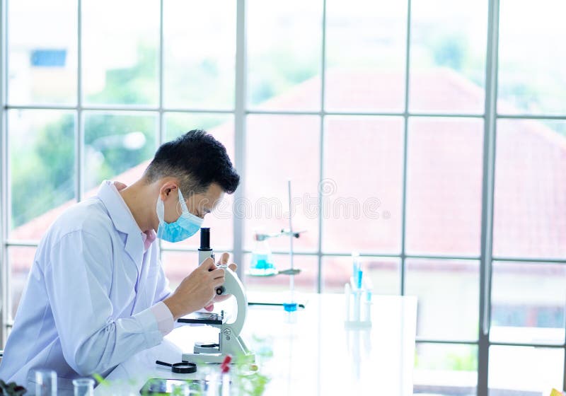 Medical Scientist Wearing Protective Surgical Mask and Lab Gown Using ...