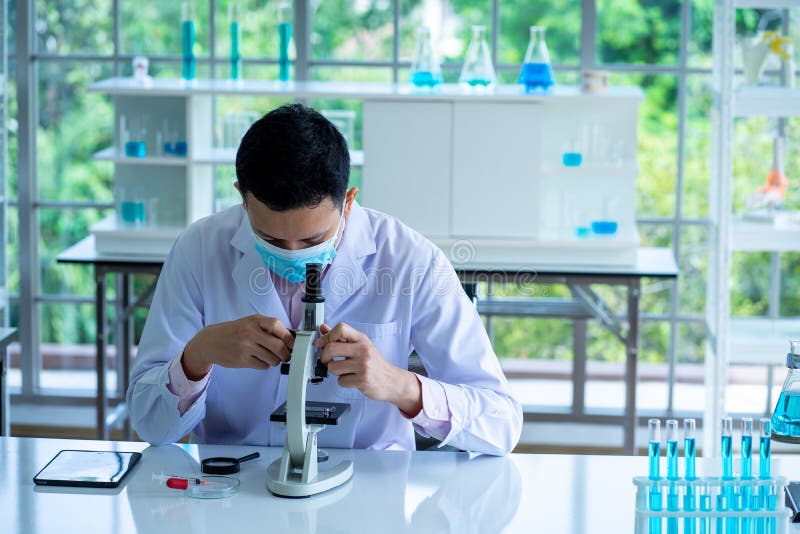 Medical Scientist Wearing Protective Surgical Mask and Lab Gown Using ...