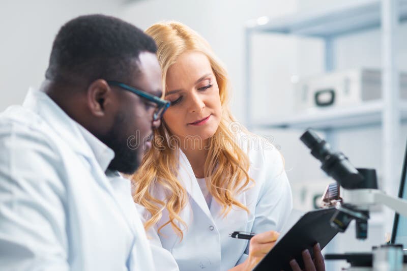 Medical Scientists Working in Lab. Doctor Teaching Interns To Make ...