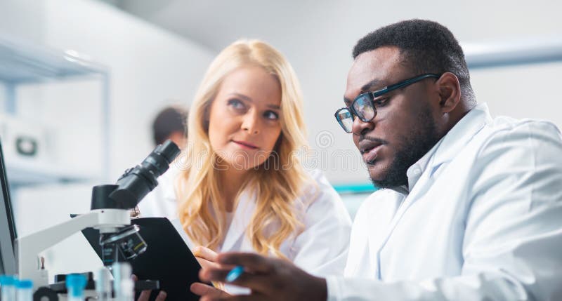 Medical Scientists Working in Lab. Doctor Teaching Interns To Make ...